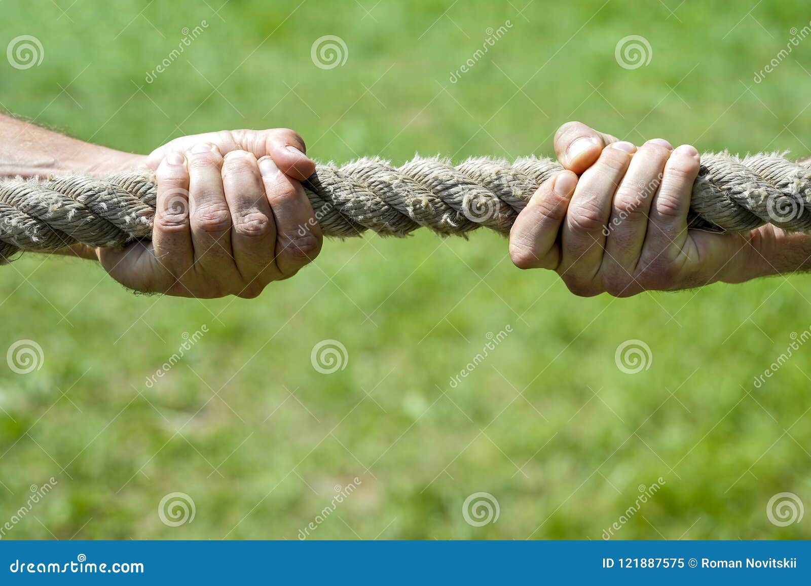 Two Men`s Hands Pull the Rope Each in His Own Direction. the Con Stock ...