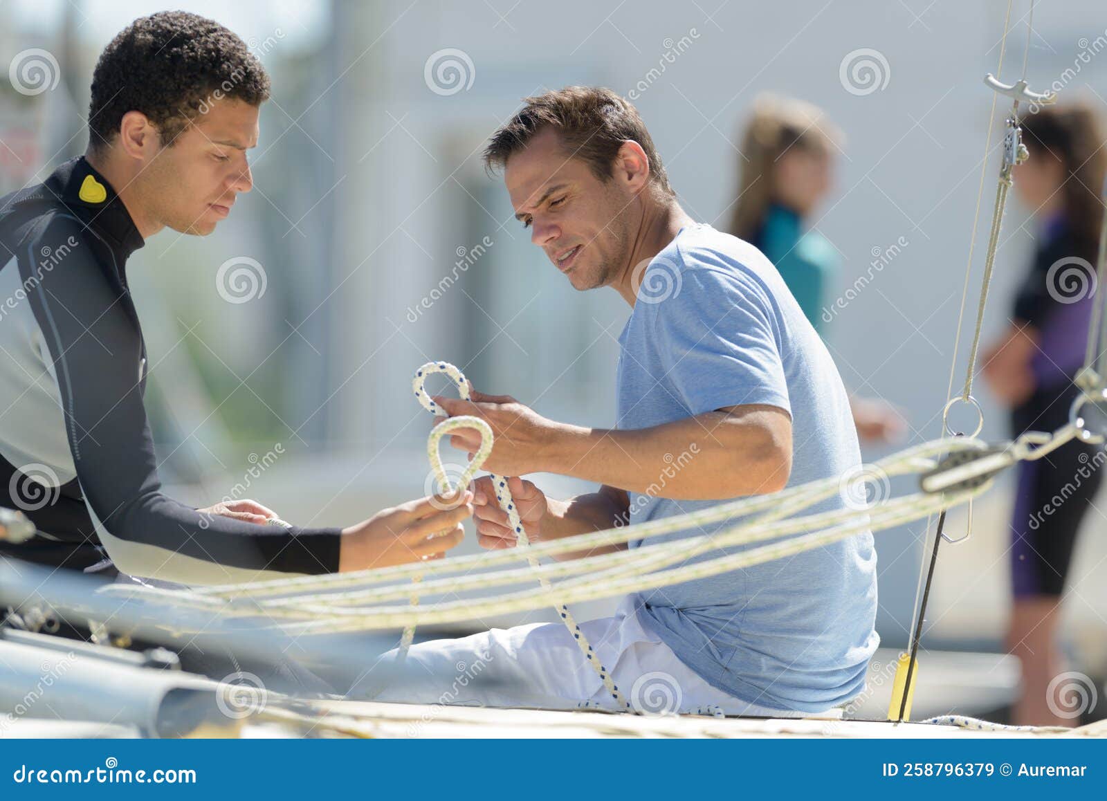 Two men sailing boat stock image. Image of 25to29years - 258796379