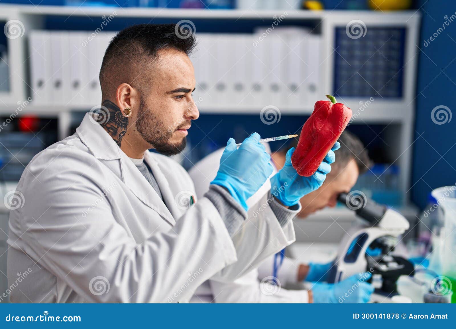 Two Men Scientist Injecting Liquid on Red Pepper Using Microscope at ...