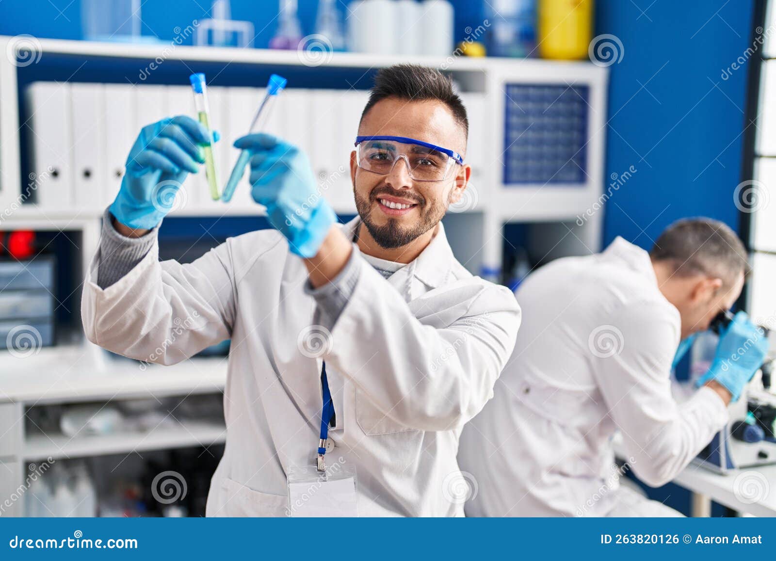 Two Men Scientists Holding Test Tubes Using Microscope at Laboratory ...