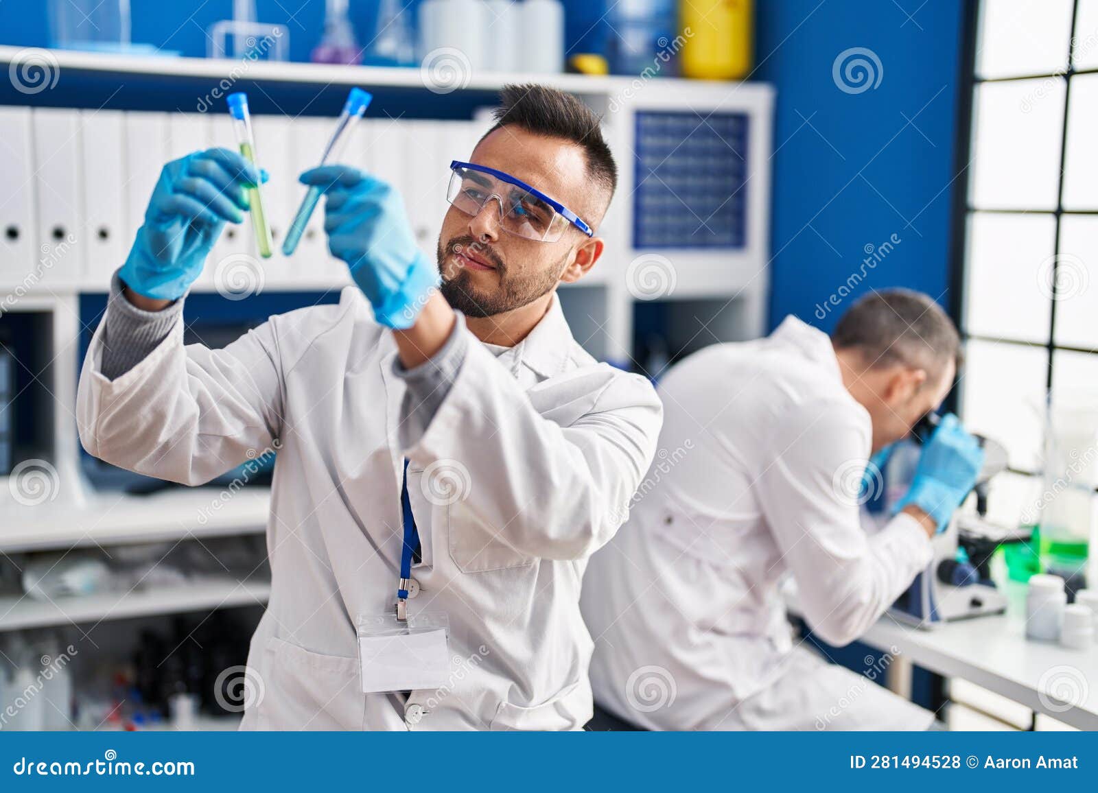 Two Men Scientists Holding Test Tubes Using Microscope at Laboratory ...