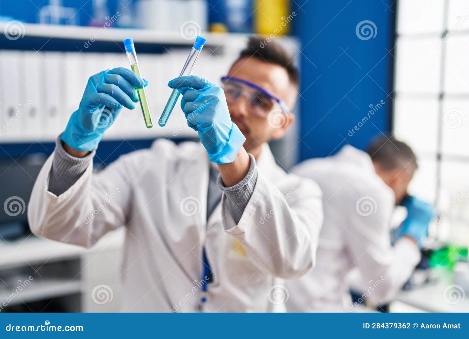 Two Men Scientists Holding Test Tubes Using Microscope at Laboratory ...