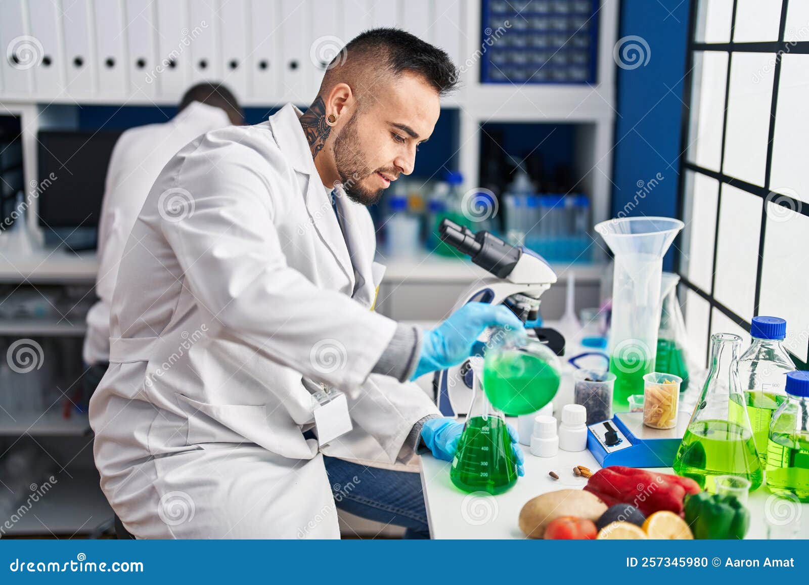 Two Men Scientists Pouring Liquid on Test Tube at Laboratory Stock ...