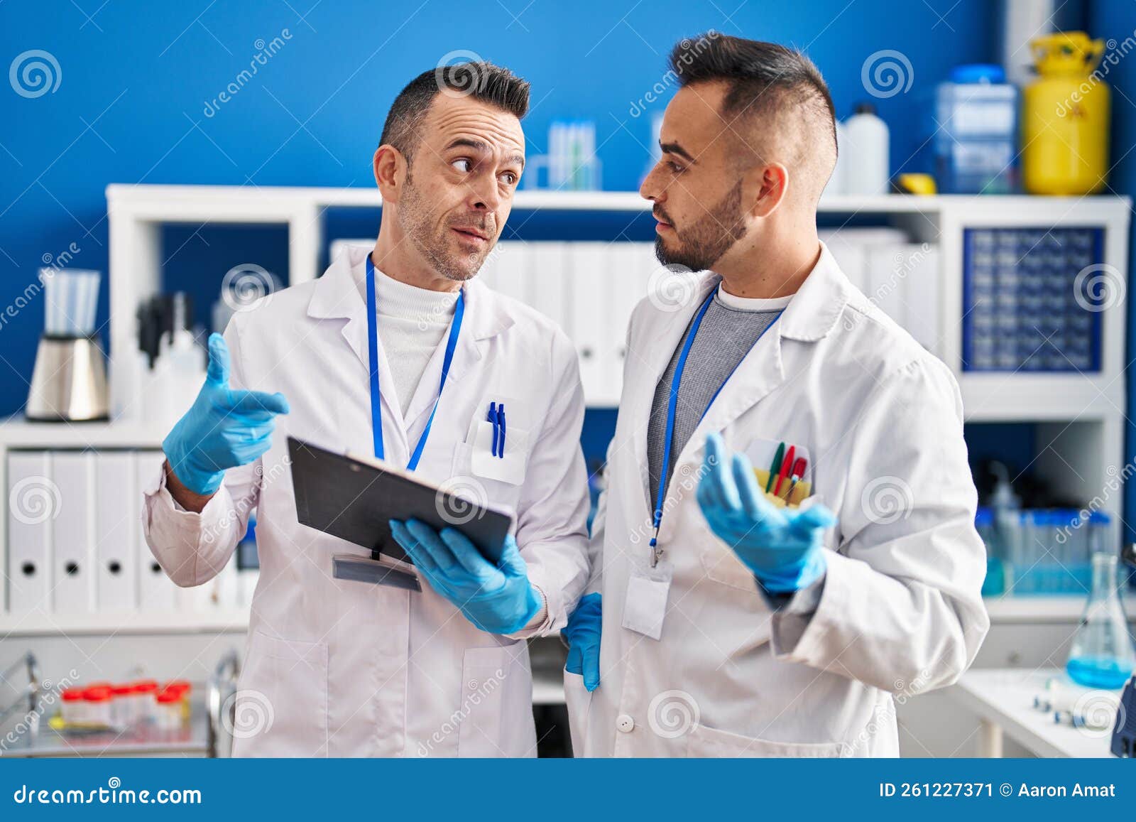 Two Men Scientists Reading Document with Relaxed Expression at ...