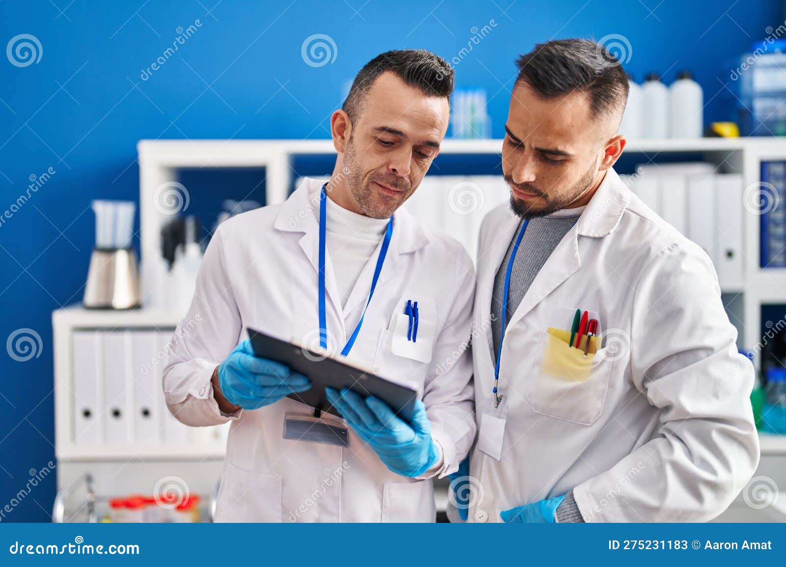 Two Men Scientists Reading Document with Relaxed Expression at ...