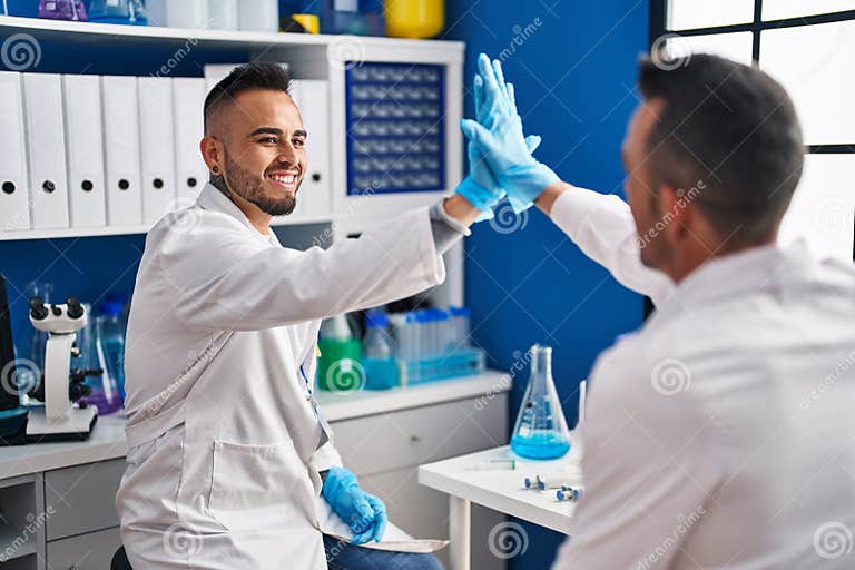 Two Men Scientists Smiling Confident High Five with Hands Raised Up at ...