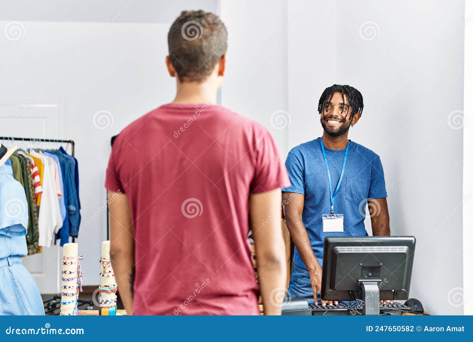 Two Men Shopkeeper and Customer Standing at Clothing Store Stock Photo ...