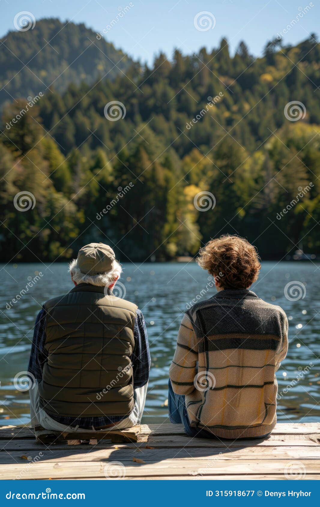 Two Men Sitting on a Dock, Focused on Fishing, Overlooking the Water ...