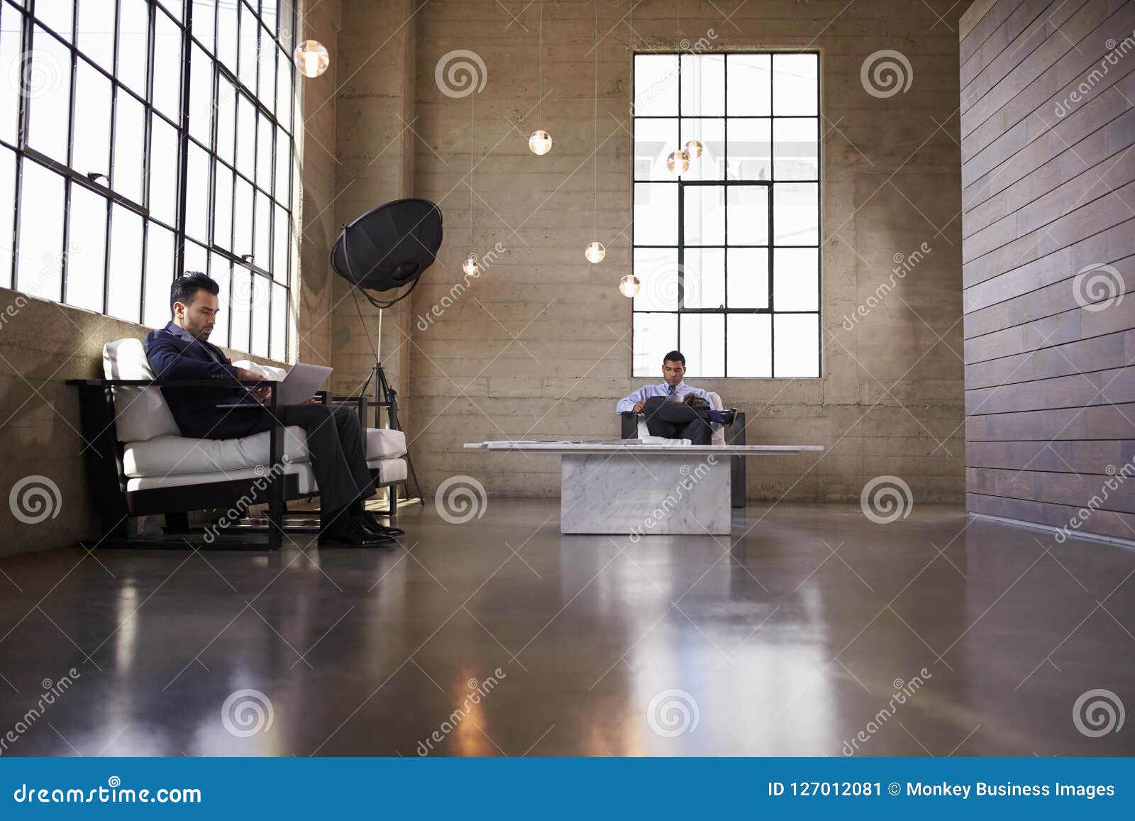 Two Men Sitting in the Foyer of a Business Building Stock Image - Image ...