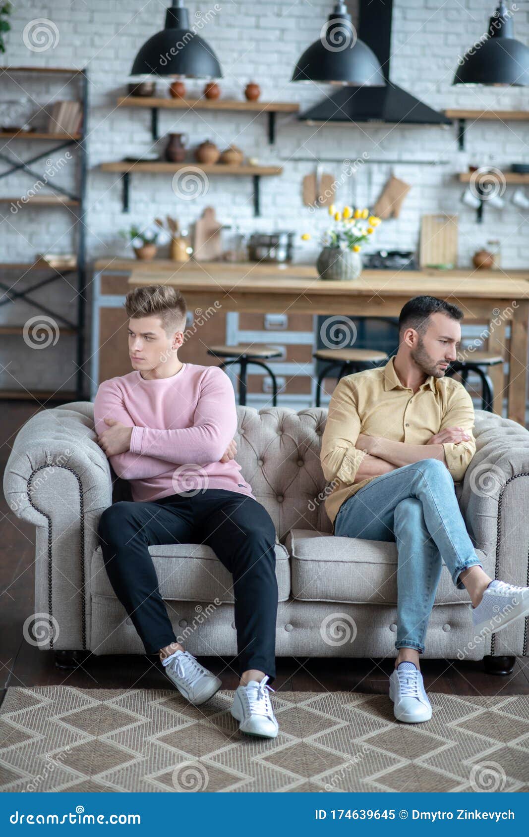 Two Men Sitting on the Sofa Not Loooking at Each Other Stock Image ...