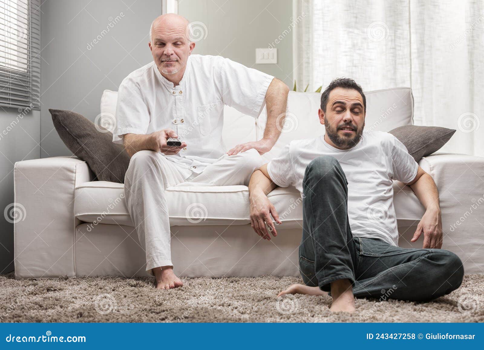 Two Men Sitting Watching a TV Program Stock Photo - Image of borring ...
