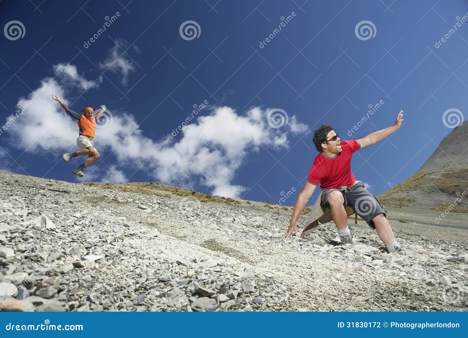 Two Men Sliding Down Scree Field Stock Photo - Image of enjoying ...