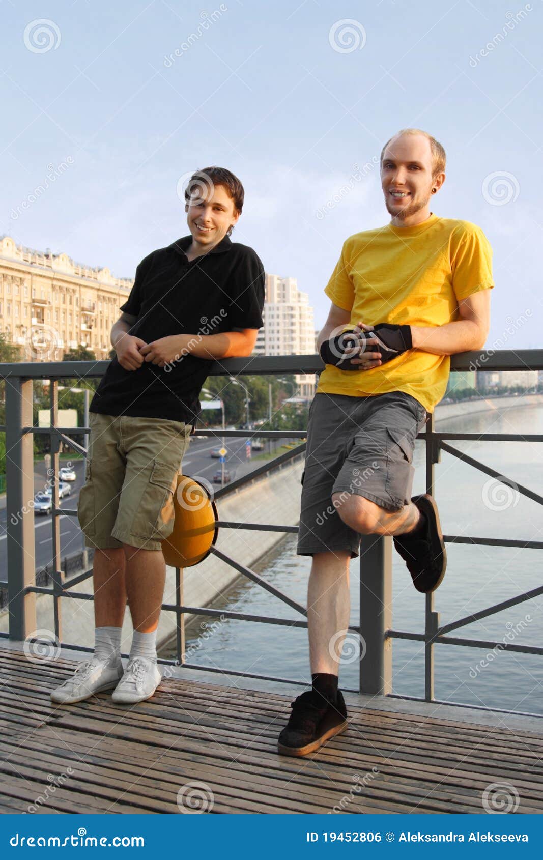 Two men standing on bridge stock photo. Image of clothes - 19452806
