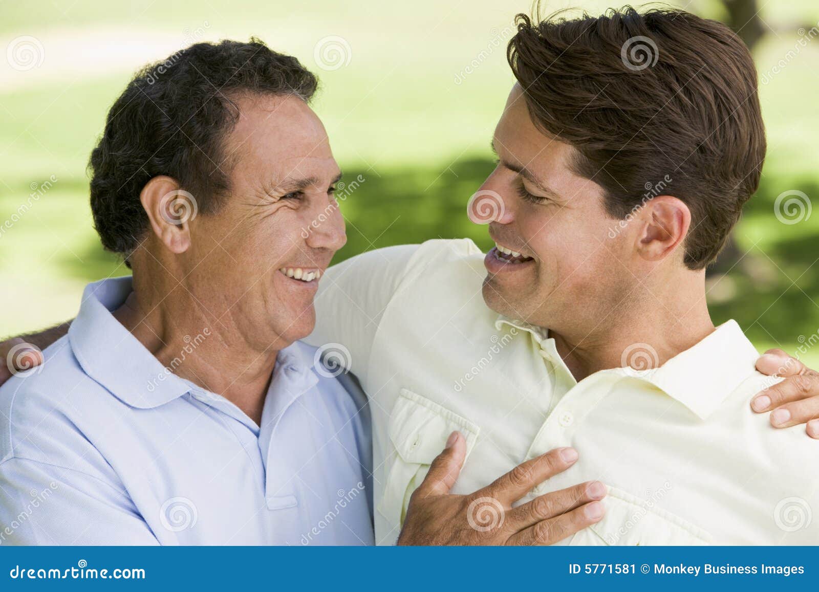 Two Men Standing Outdoors Bonding and Smiling Stock Image - Image of ...