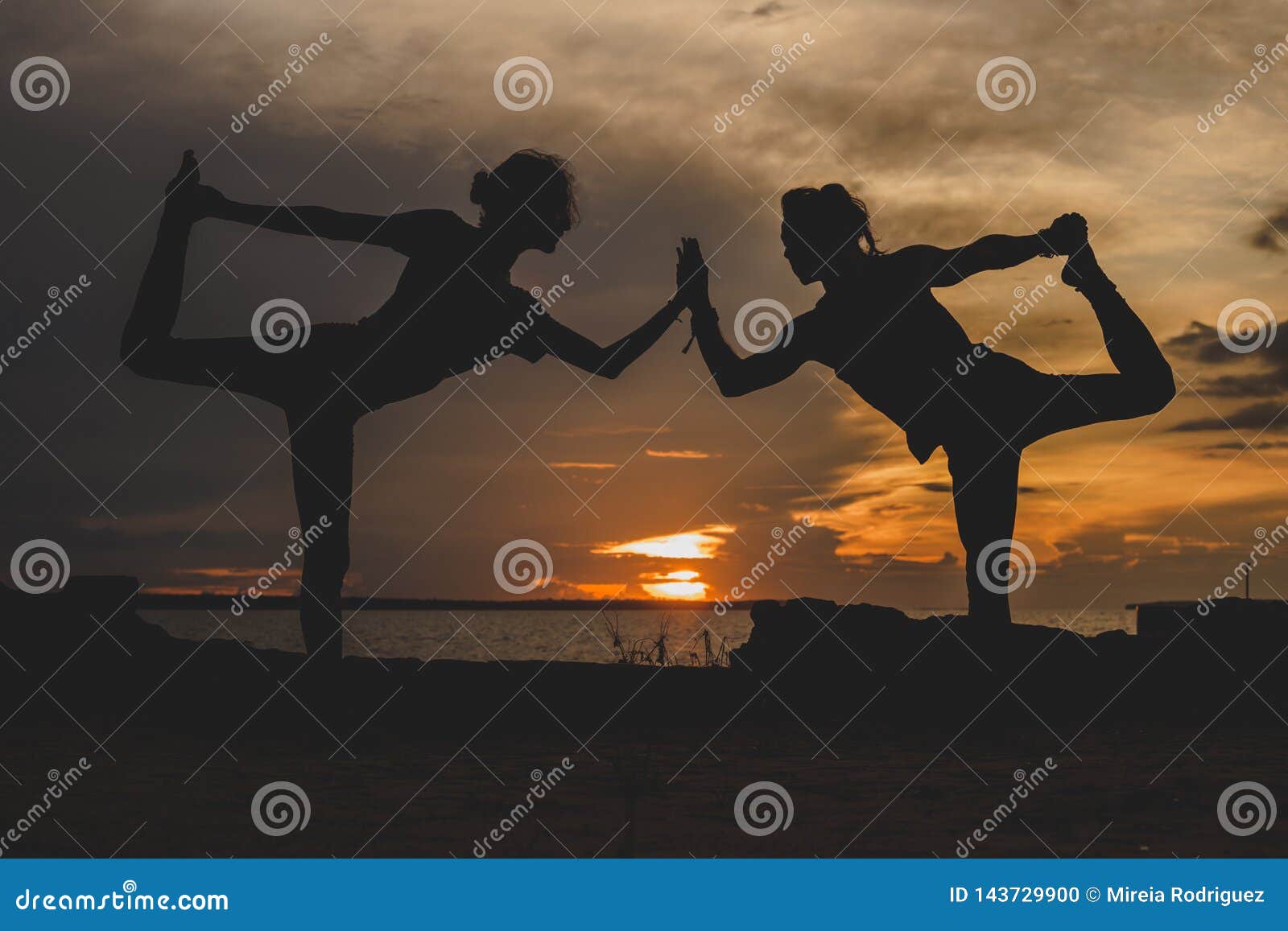 Two Men Stay in Balance while Doing Yoga Postures Stock Photo - Image ...