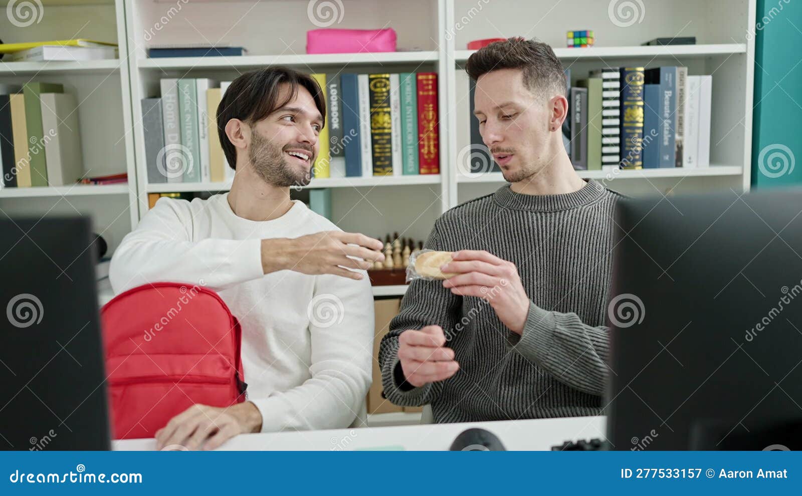 Two Men Students Using Computer Eating Dough at Library University ...
