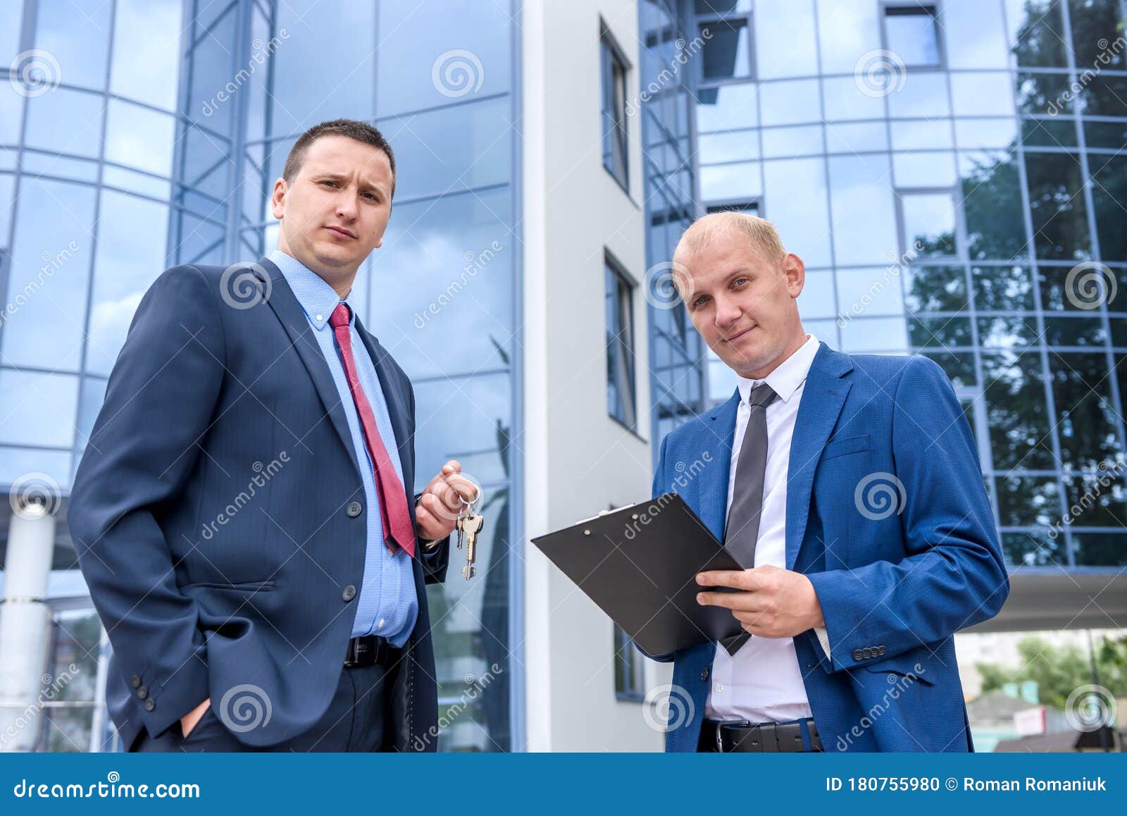 Two Men in Suits with Clipboard and Keys Negotiate Stock Photo - Image ...