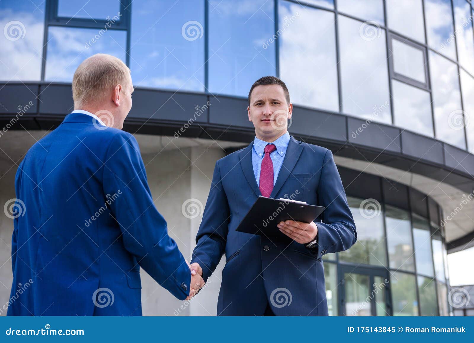 Two Men in Suits Handshaking Opposite Building Stock Image - Image of ...