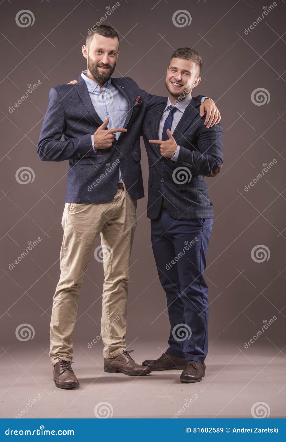 Two men in suits hugging stock image. Image of group - 81602589