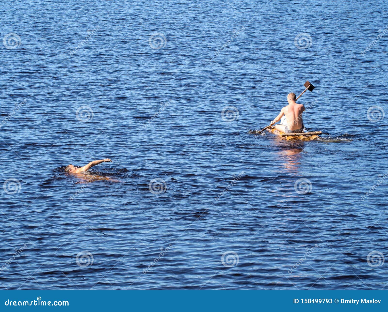 Two men swim in the water stock image. Image of adventure - 158499793