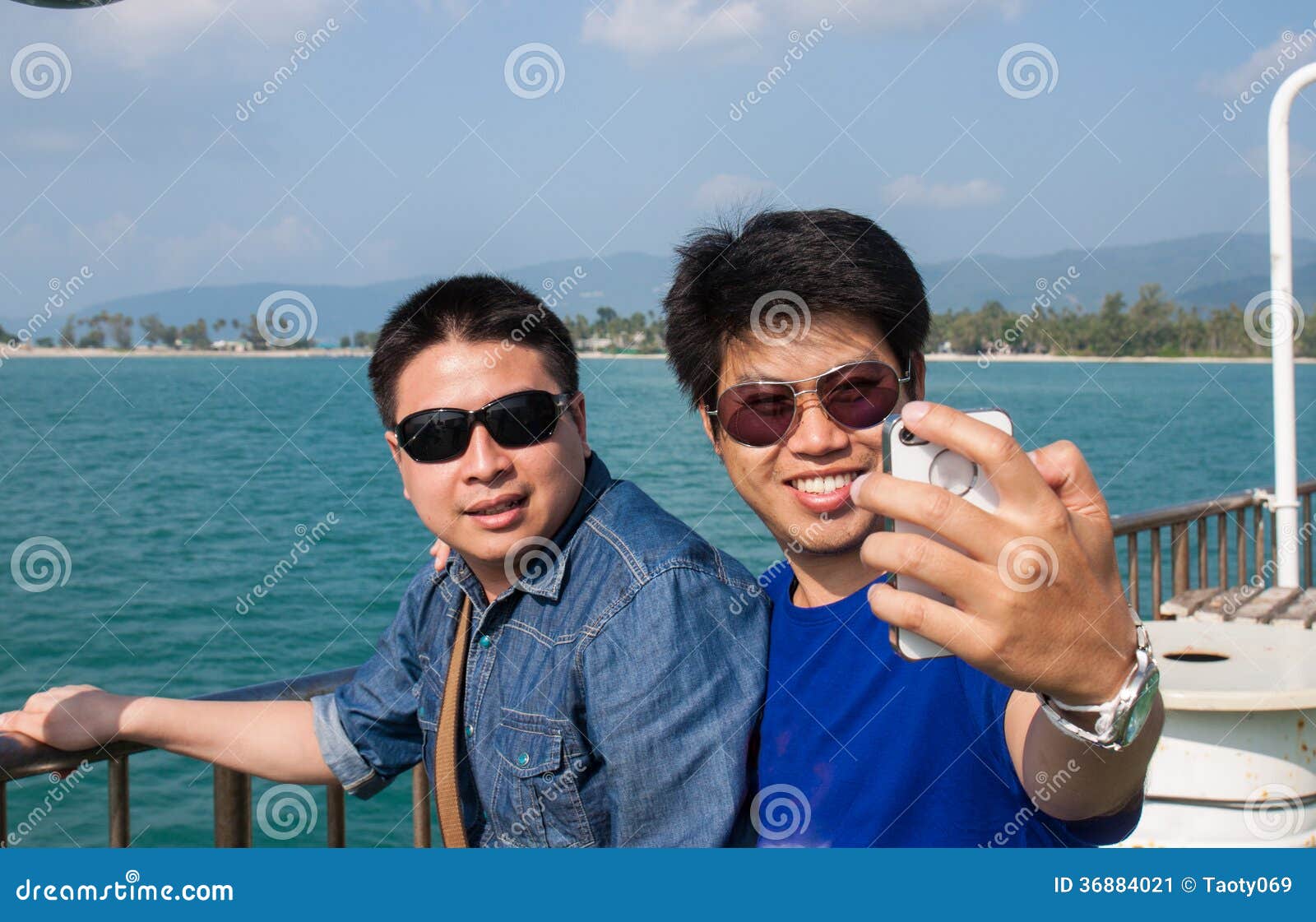 Two men stock image. Image of side, holiday, phone, ocean - 36884021