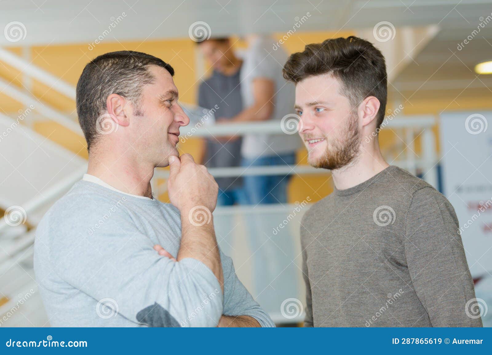 Two Men Talking in Corridor Stock Image - Image of twopeople, talking ...