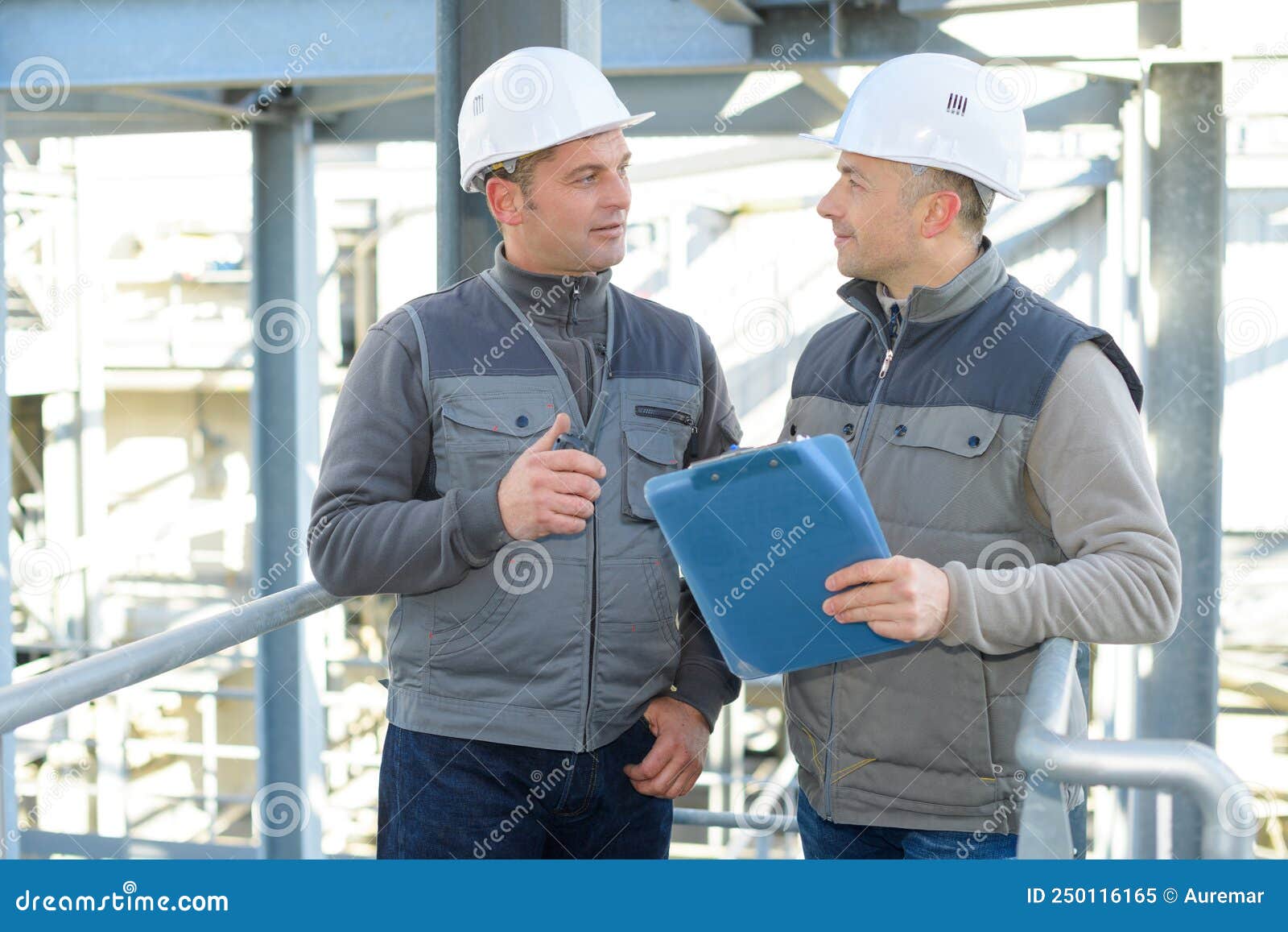 Two Men Talking in Factory Shop Floor Stock Image - Image of hold ...