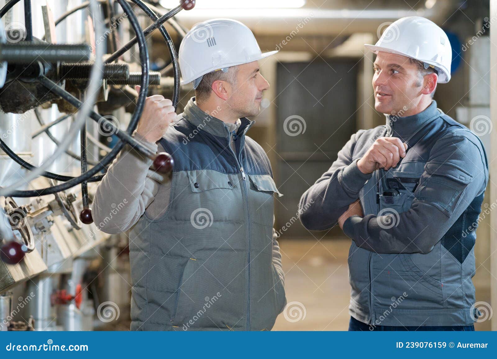 Two Men Talking Inside Industrial Factory Stock Image - Image of senior ...