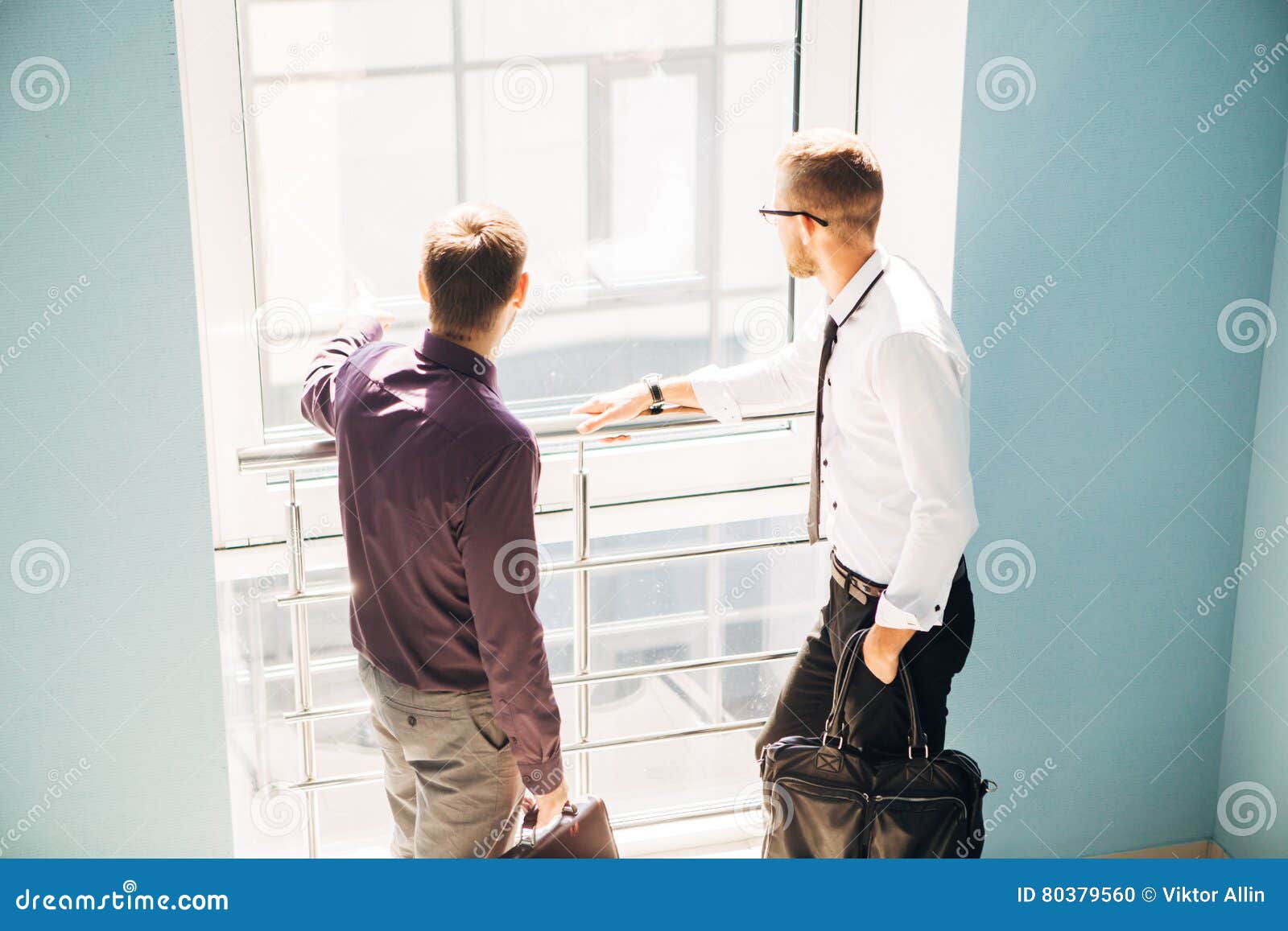 Two Men Talking in the Lobby of the Office Stock Photo - Image of ...