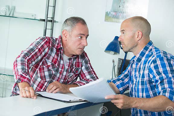 Two Men Talking Over Counter Stock Image - Image of spending, store ...