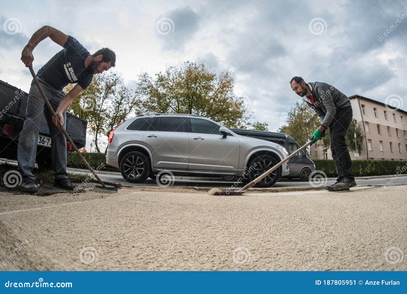 Two Men Using Shovels at a Construction Site Stock Image - Image of ...