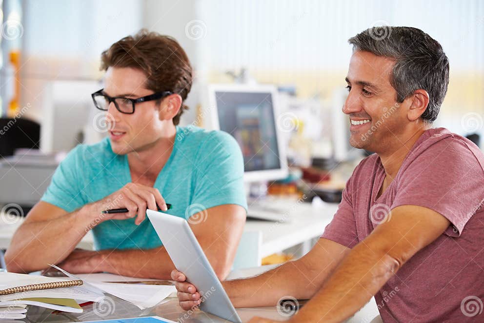 Two Men Using Tablet Computer in Creative Office Stock Image - Image of ...