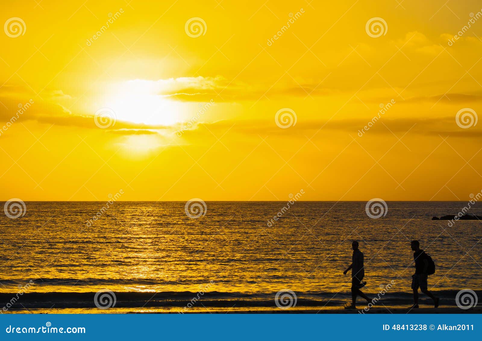 Two men walking at sunset stock photo. Image of arms - 48413238
