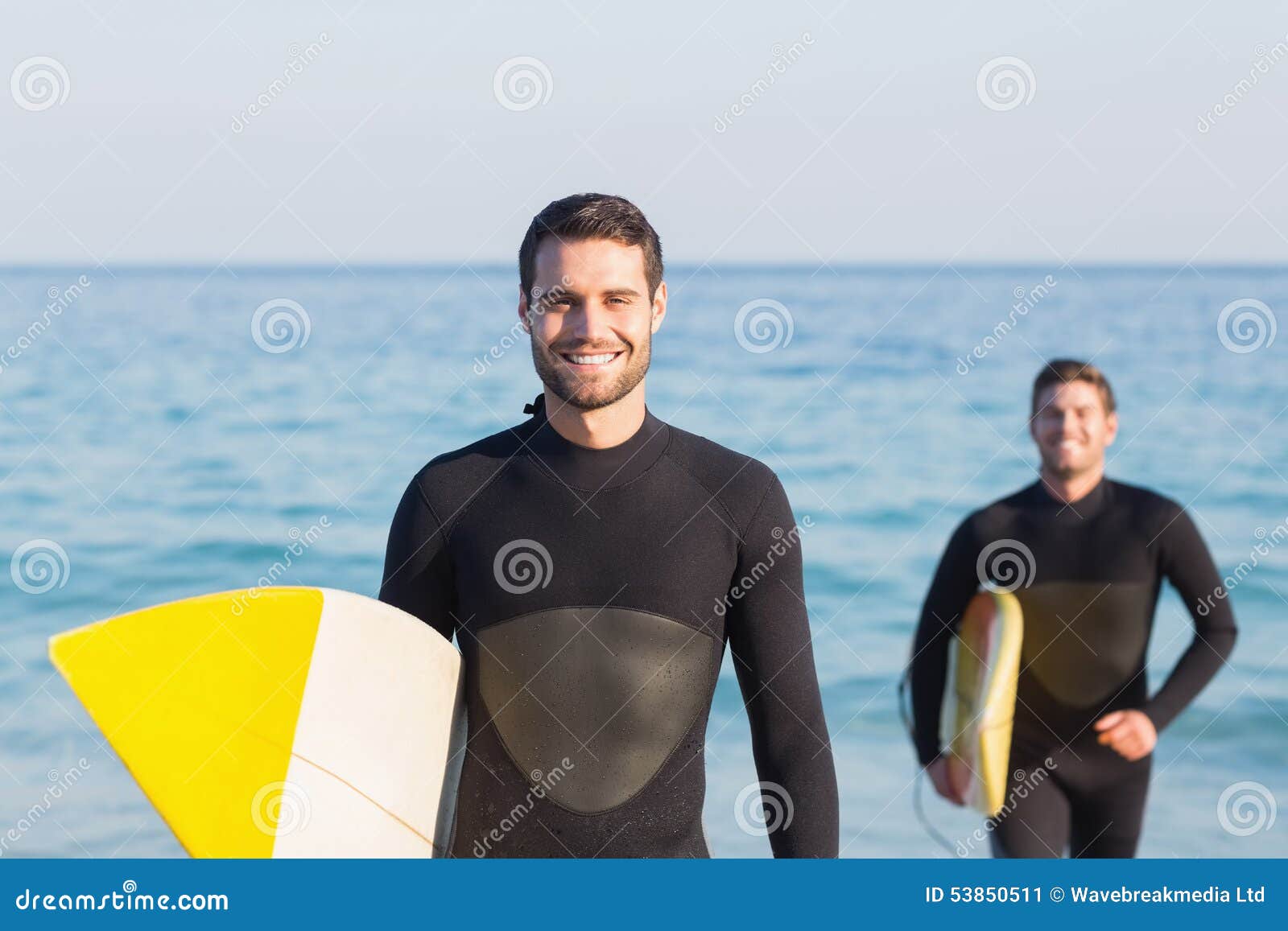 Two Men in Wetsuits with a Surfboard on a Sunny Day Stock Image - Image ...