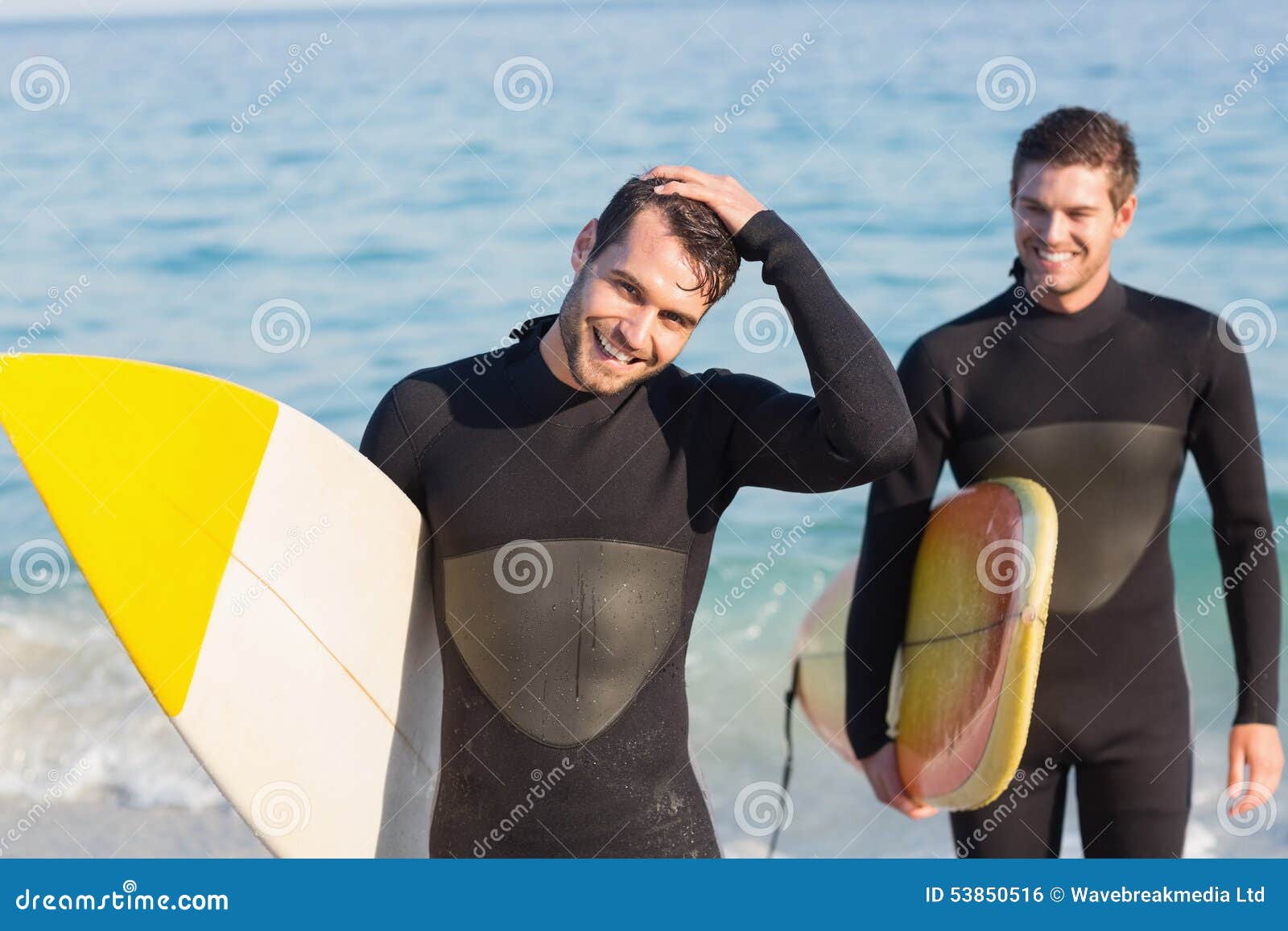 Two Men in Wetsuits with a Surfboard on a Sunny Day Stock Photo - Image ...