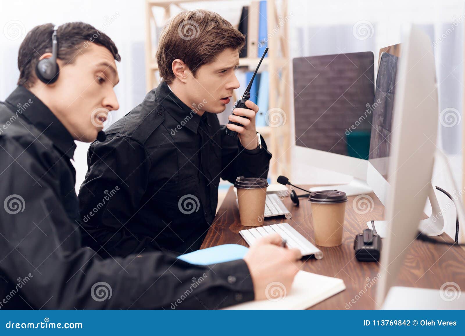 Two men work as guards. stock photo. Image of data, record - 113769842