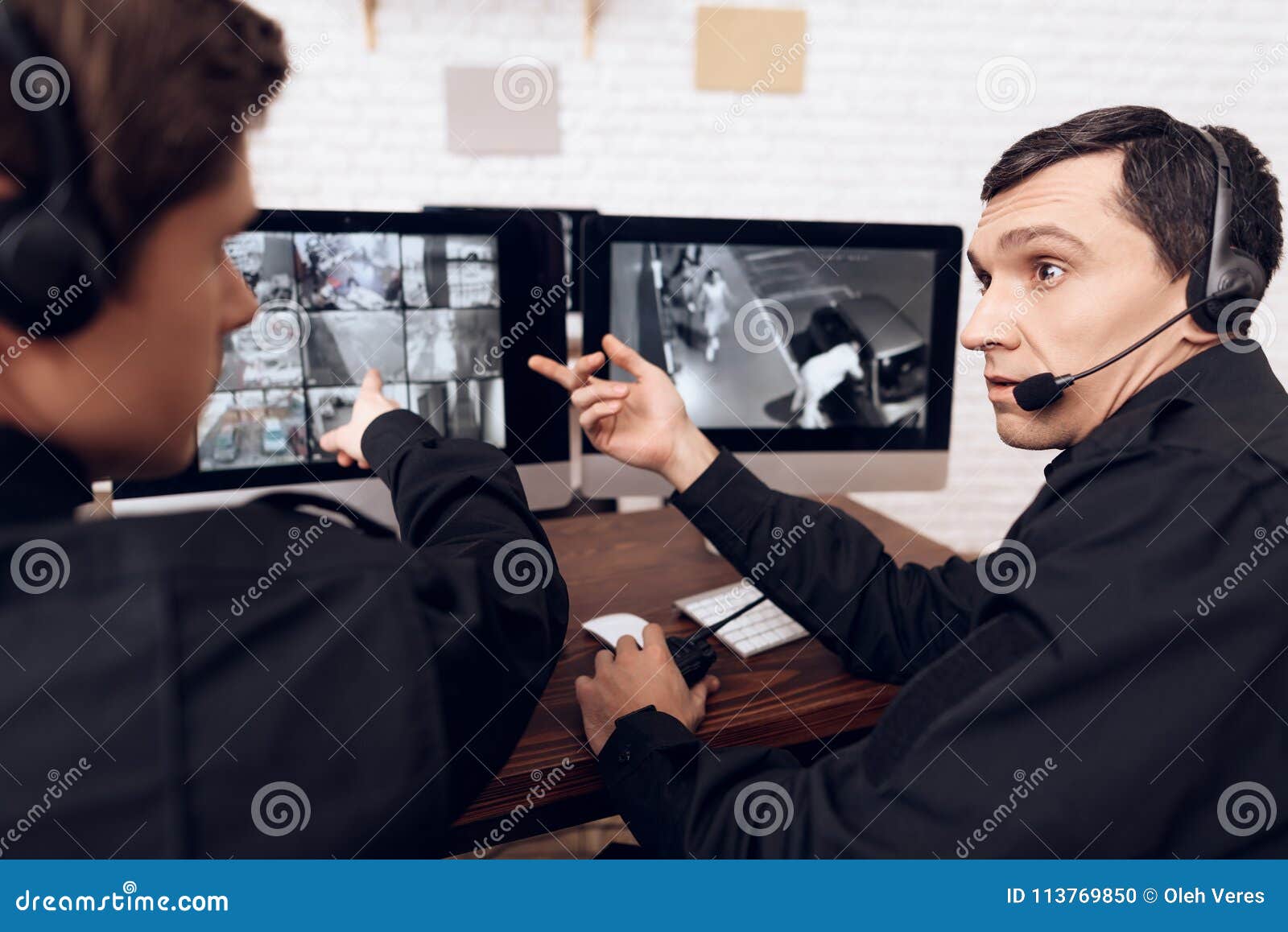 Two men work as guards. stock photo. Image of information - 113769850