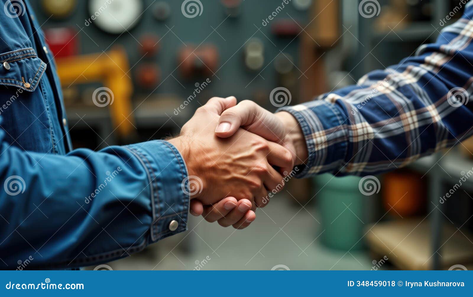 Two Men in Work Clothes Exchange Handshake in Industrial Workshop ...