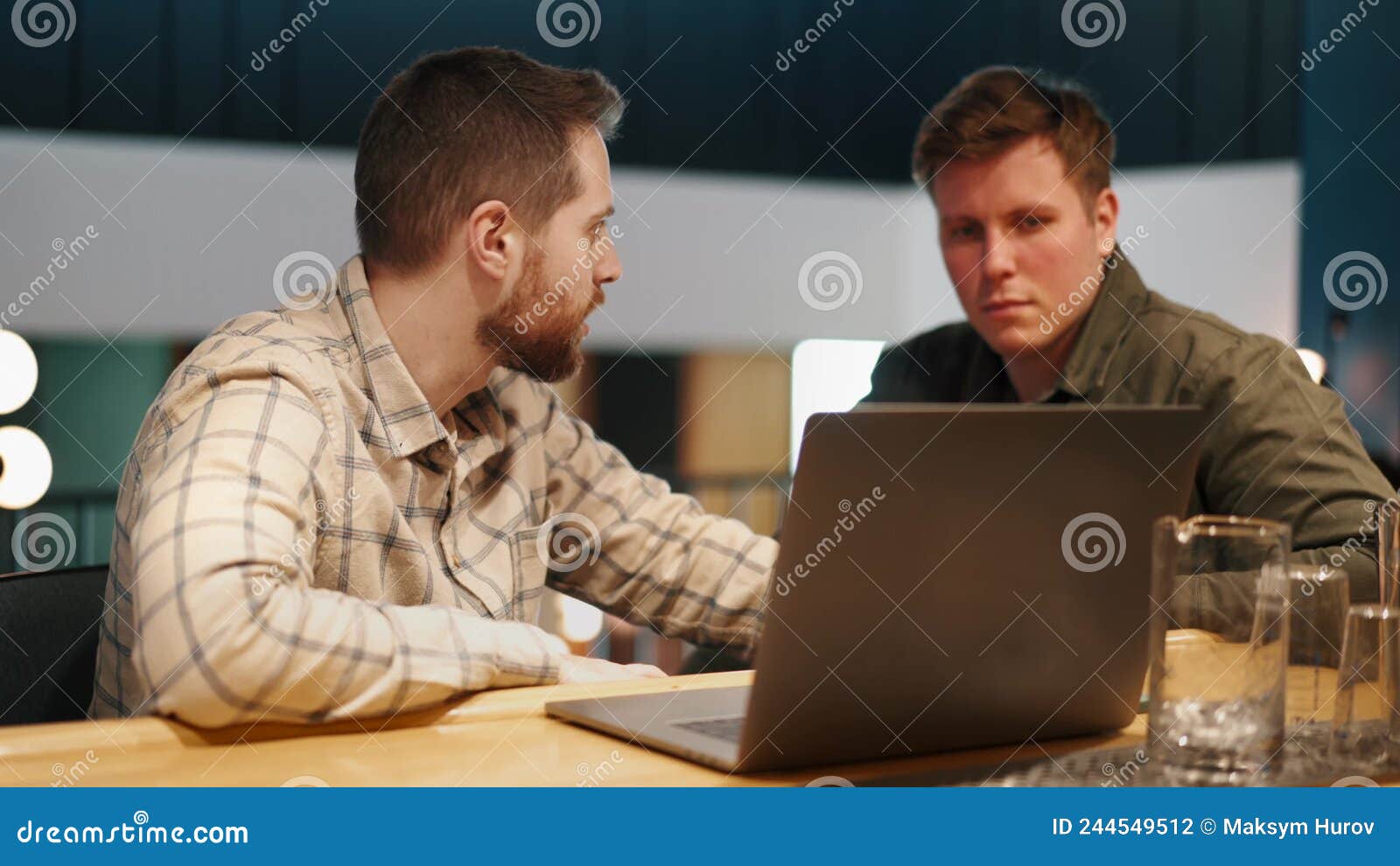 Two Men Work at a Computer in a Coworking Space, Sitting at the Bar ...
