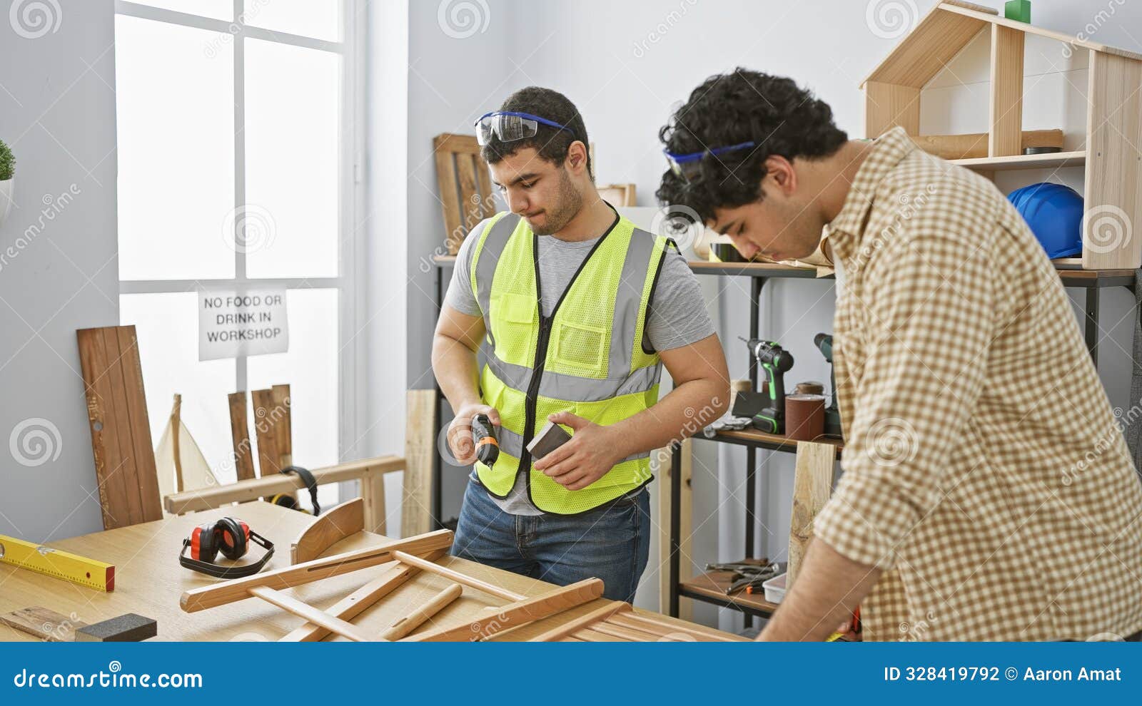 Two Men Work Together in a Bright Carpentry Workshop, Measuring and ...