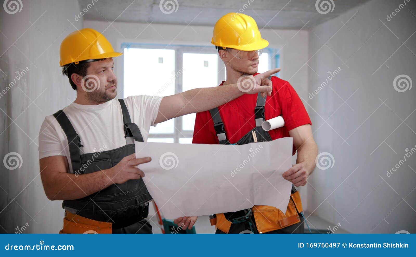 Two Men Workers Looking at the Layout Stock Image - Image of renovation ...