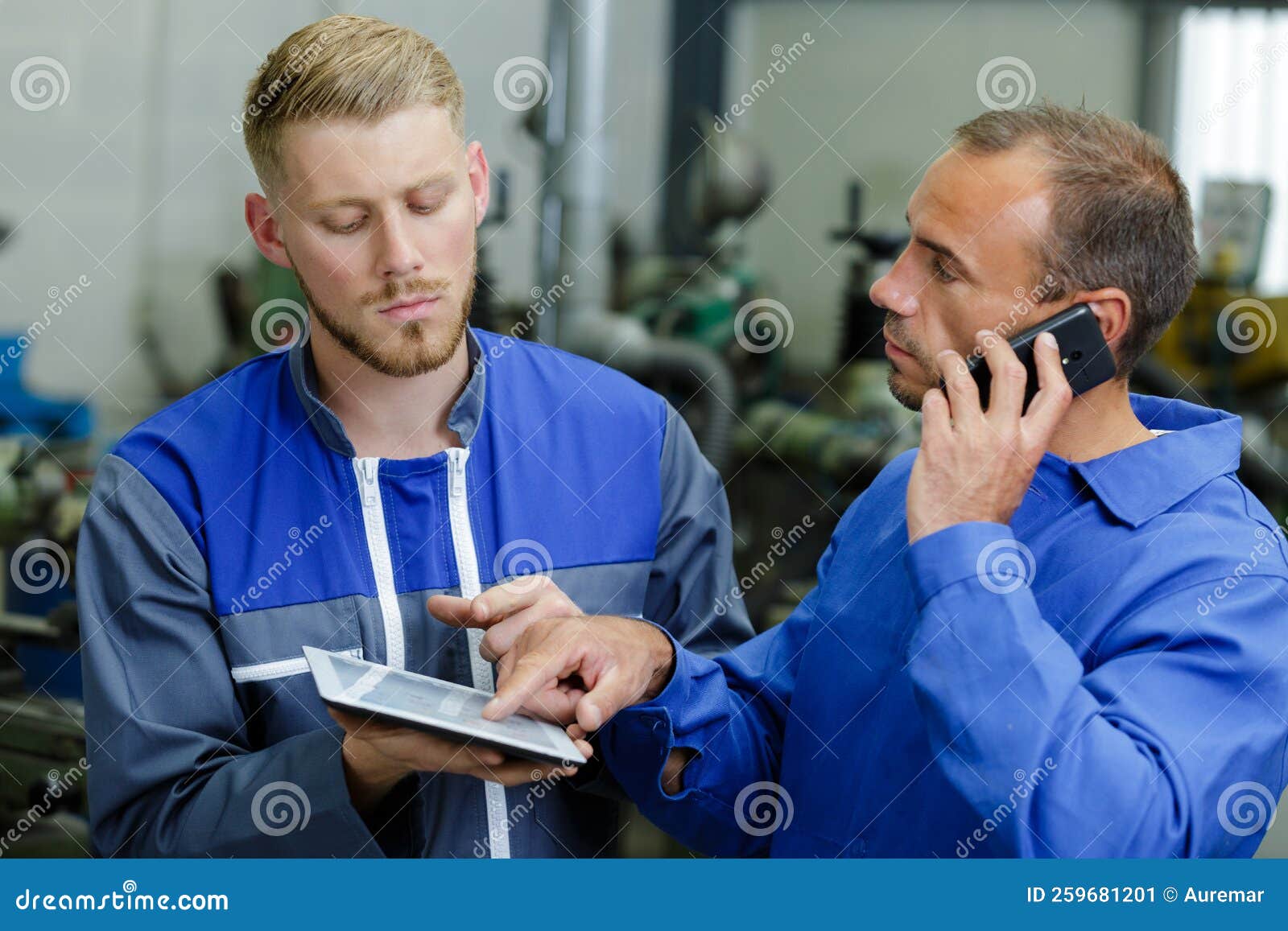Two men working in garage stock image. Image of male - 259681201