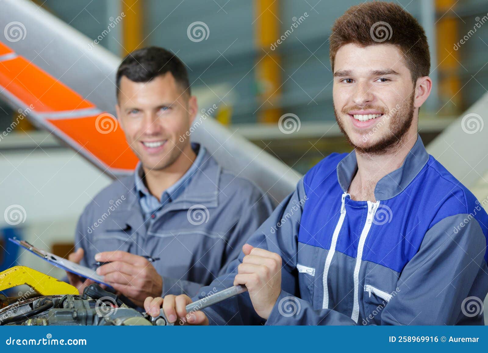 Two men working on machine stock photo. Image of machine - 258969916
