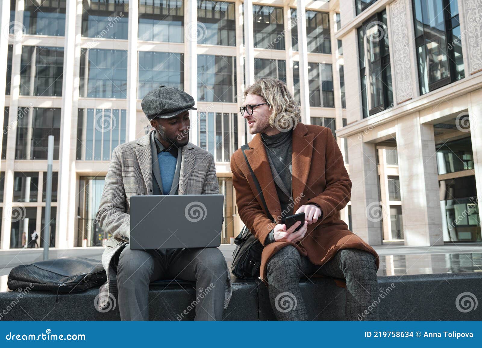 Two men working outdoors stock photo. Image of looking - 219758634