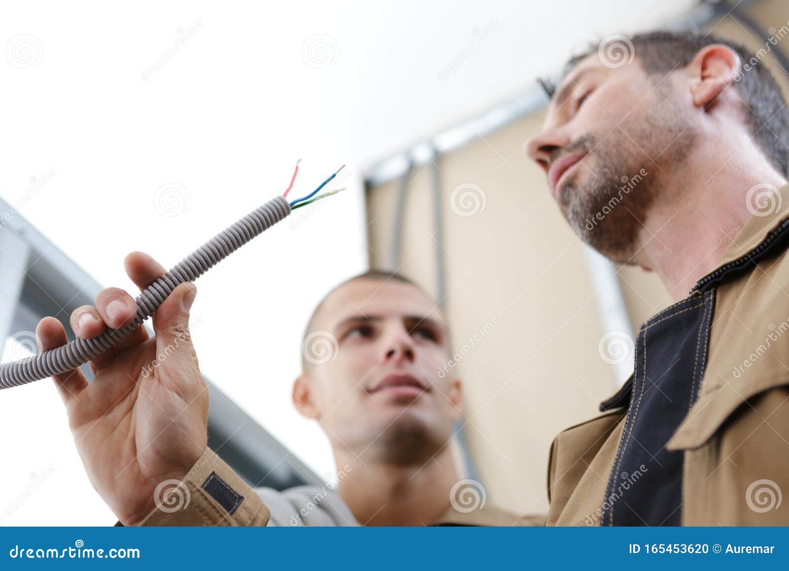 Two Men Working Together with Electricity Stock Photo - Image of power ...