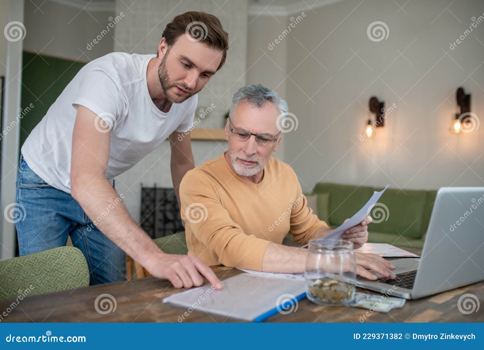 Two Men Working Together on a Project and Looking Involved Stock Photo ...