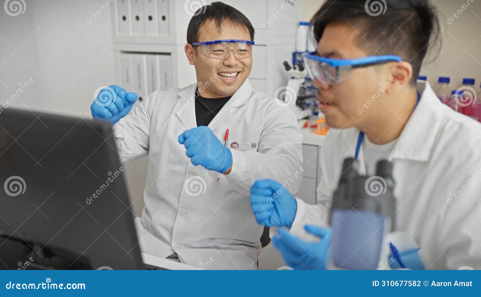 Two Men Working Together in a Science Laboratory, Analyzing Results on ...