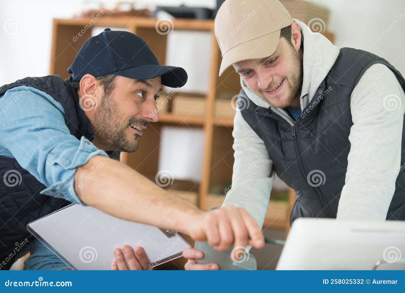 Two Men in Workshop Looking at Computer Screen Stock Photo - Image of ...