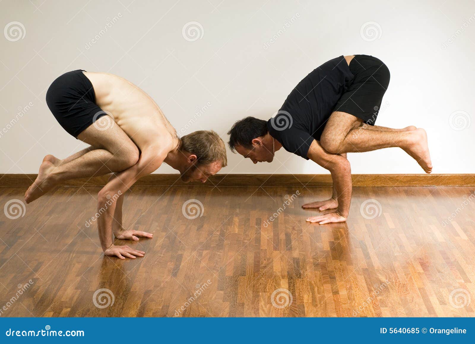 Two Men In A Yoga Crouch - Horizontal Picture. Image: 5640685