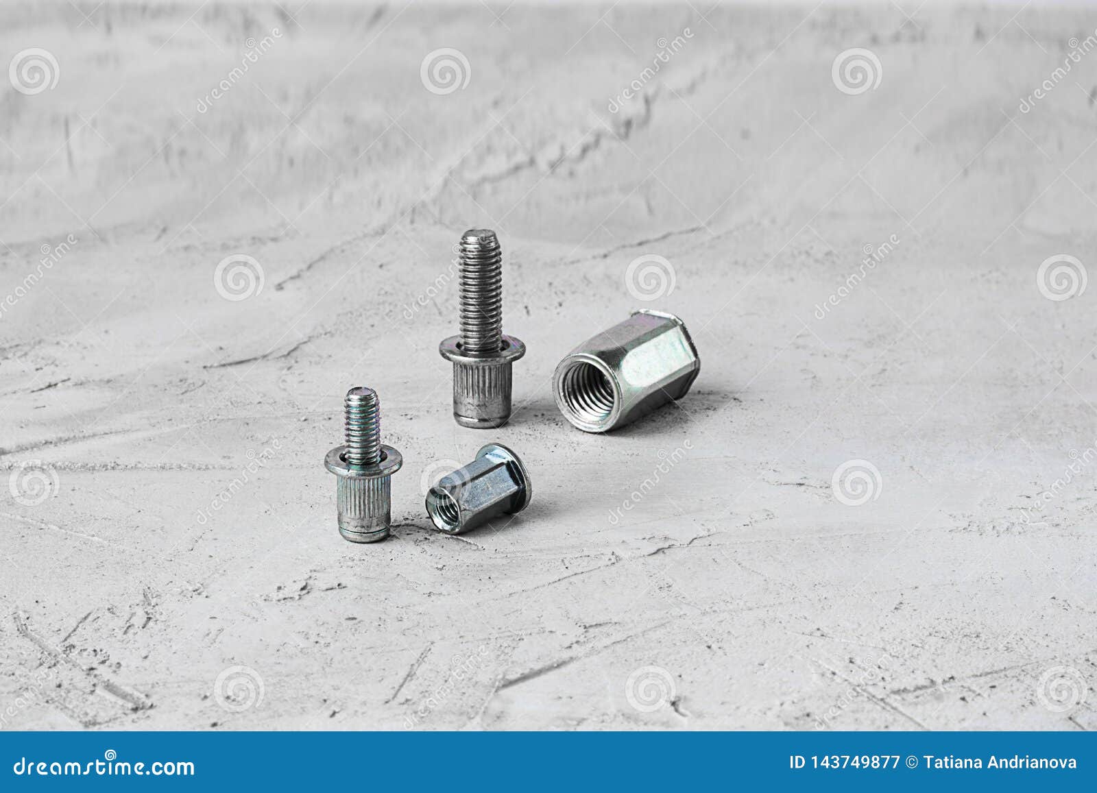 Two Metal Pop Rivet Fasteners of Different Size, on Grey Cement ...